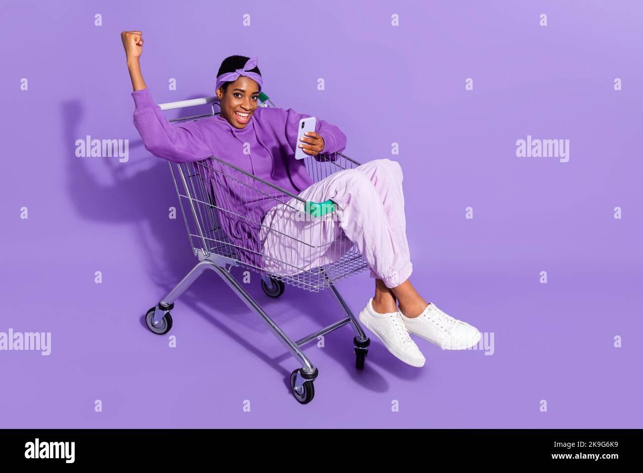 Photo of transgender person sit trolley hold phone rejoice wear ...