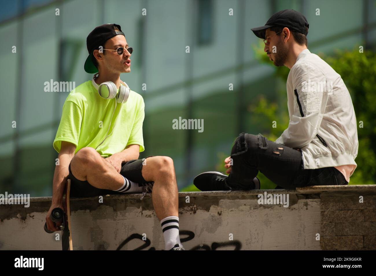 Two best friends are having a conversation while sitting Stock Photo ...