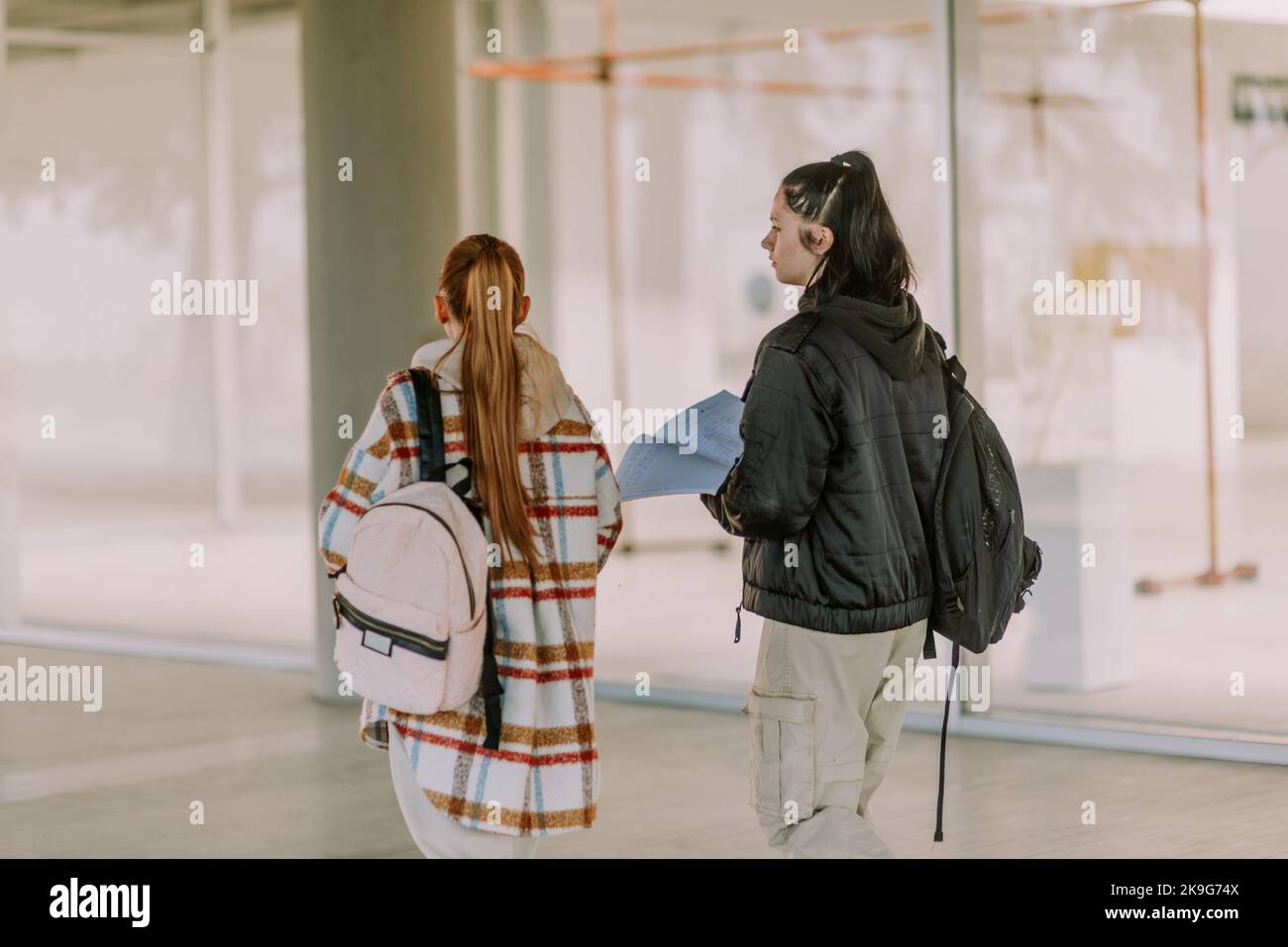 School break's over. Two girls, one blonde and one brunette are going ...