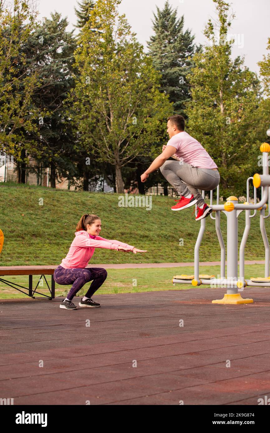 Amazing and beautiufl couple is doing some jumping exercise together in ...