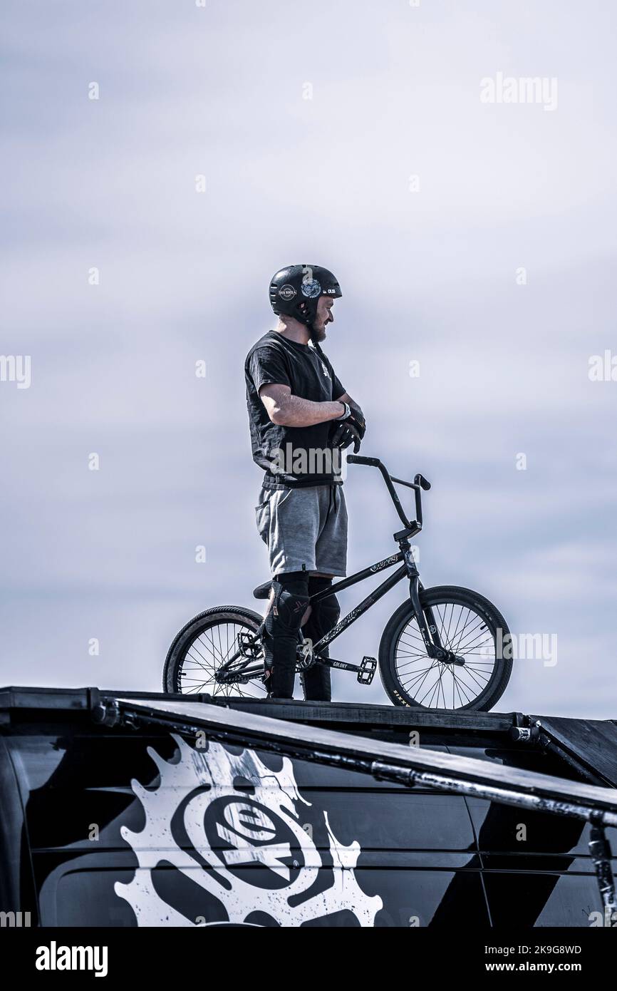 a vertical shot of a BMX rider about to ride down the ramp Stock Photo ...