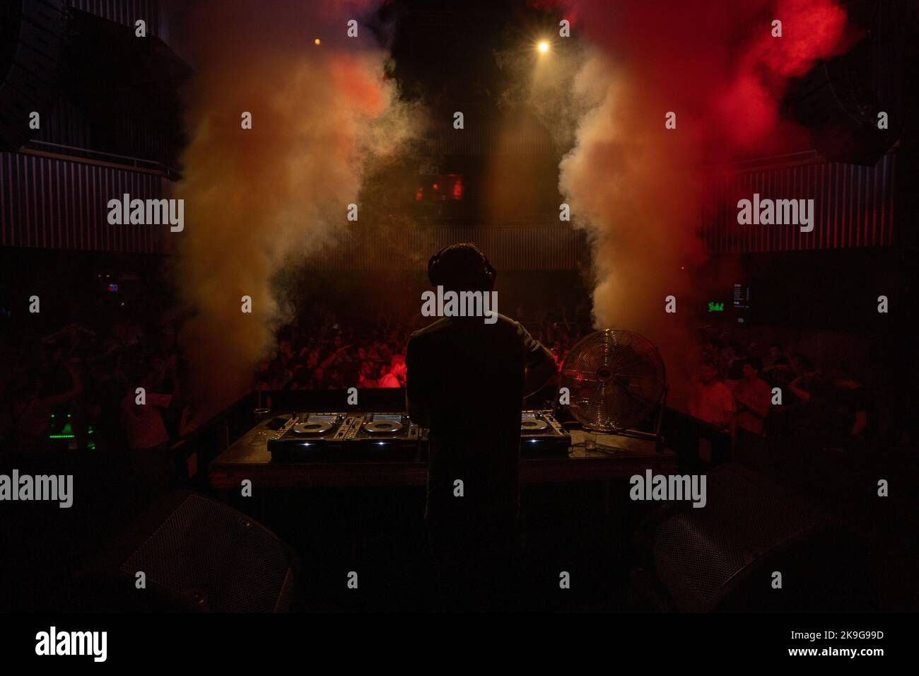 A back view of DJ on stage during the end party of ELCID student ...