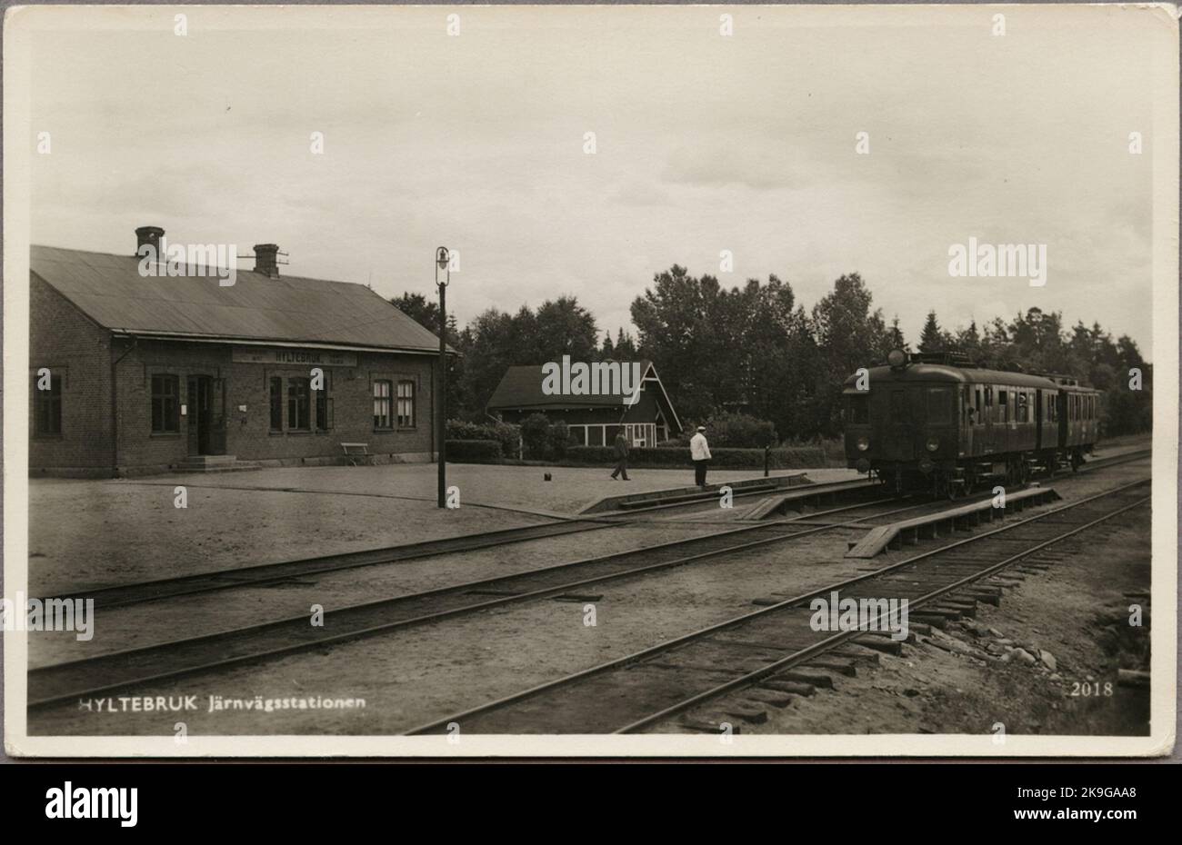 Station area with track side of station house and motor carriage at ...