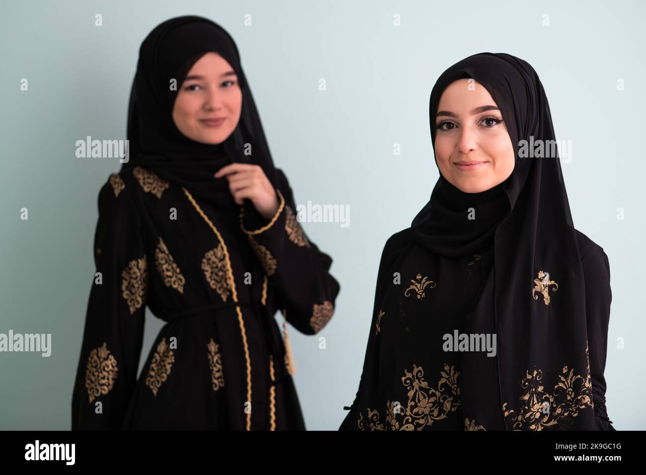 Two beautiful muslim woman in fashinable dress with hijab isolated on ...