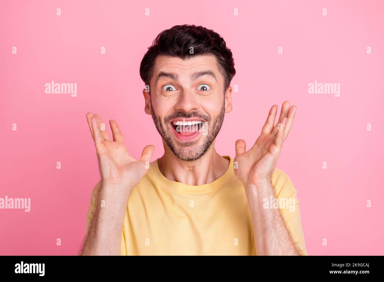 Portrait of positive good mood man with stylish haircut wear yellow t ...