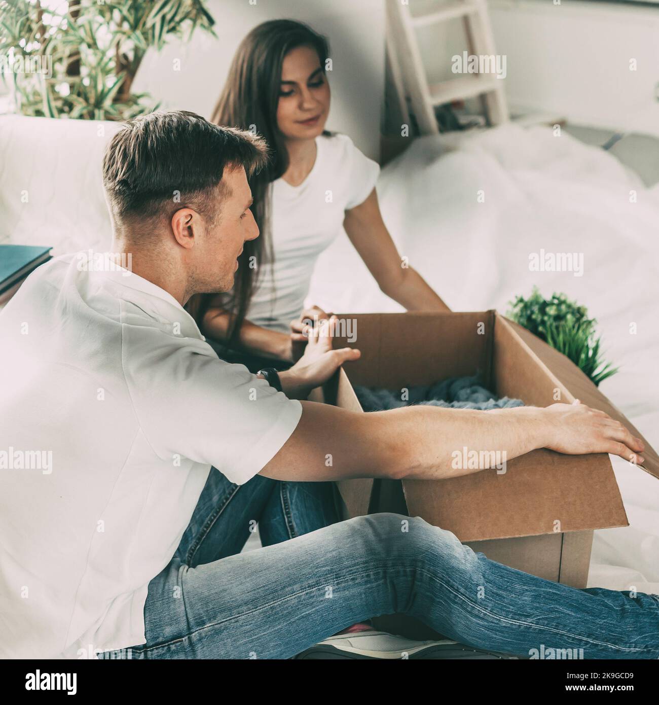 close up. couple opening a cardboard box in a new apartment Stock Photo ...