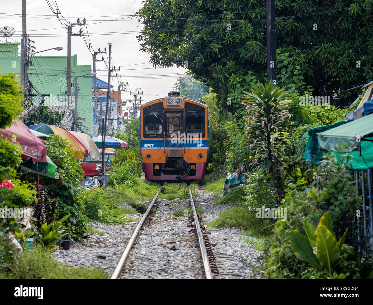 A view of the colorful urban train on rails in Thailand Stock Photo - Alamy