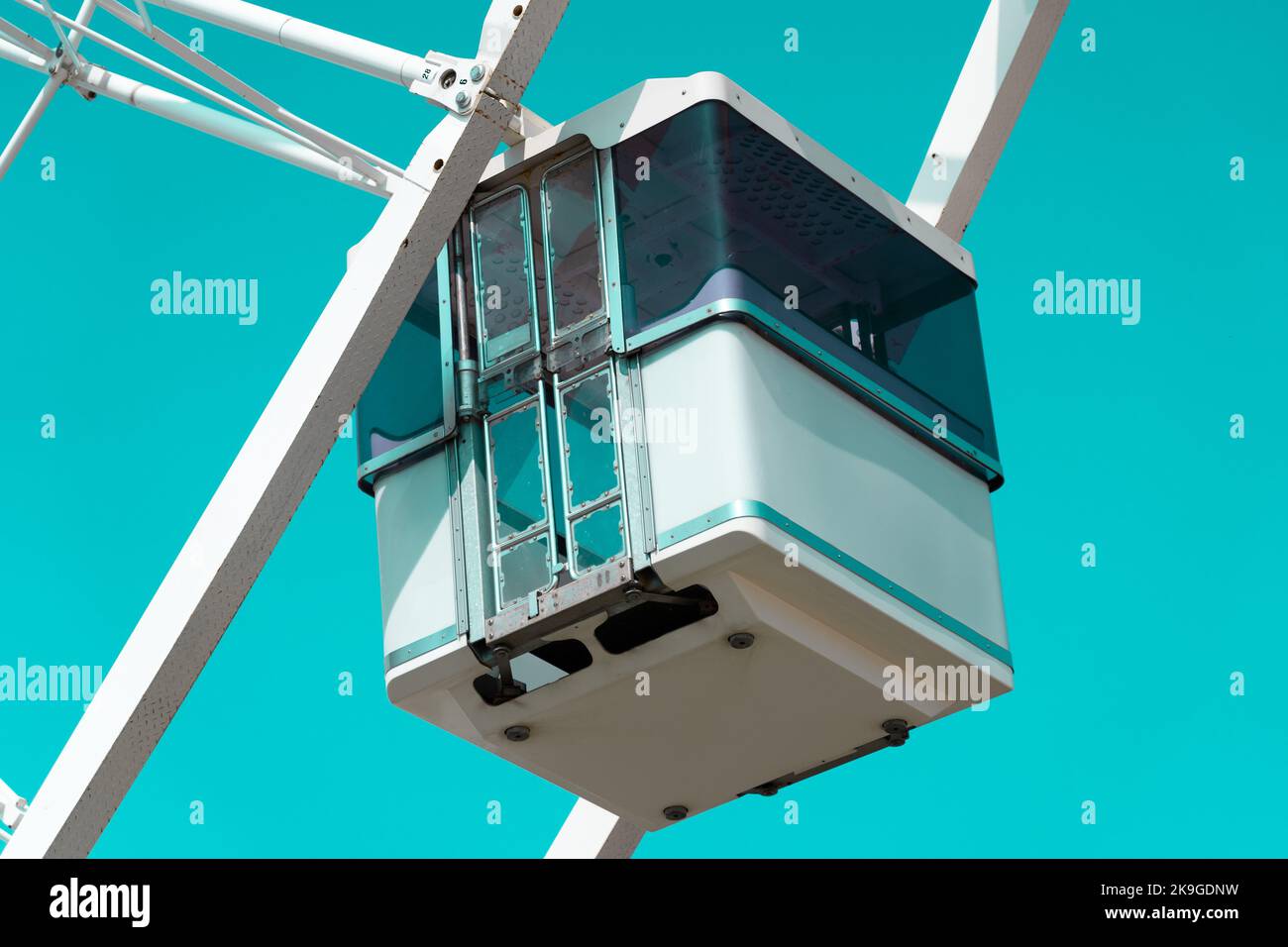 The low-angle view of the Ferris wheel cabin before the blue sky Stock ...