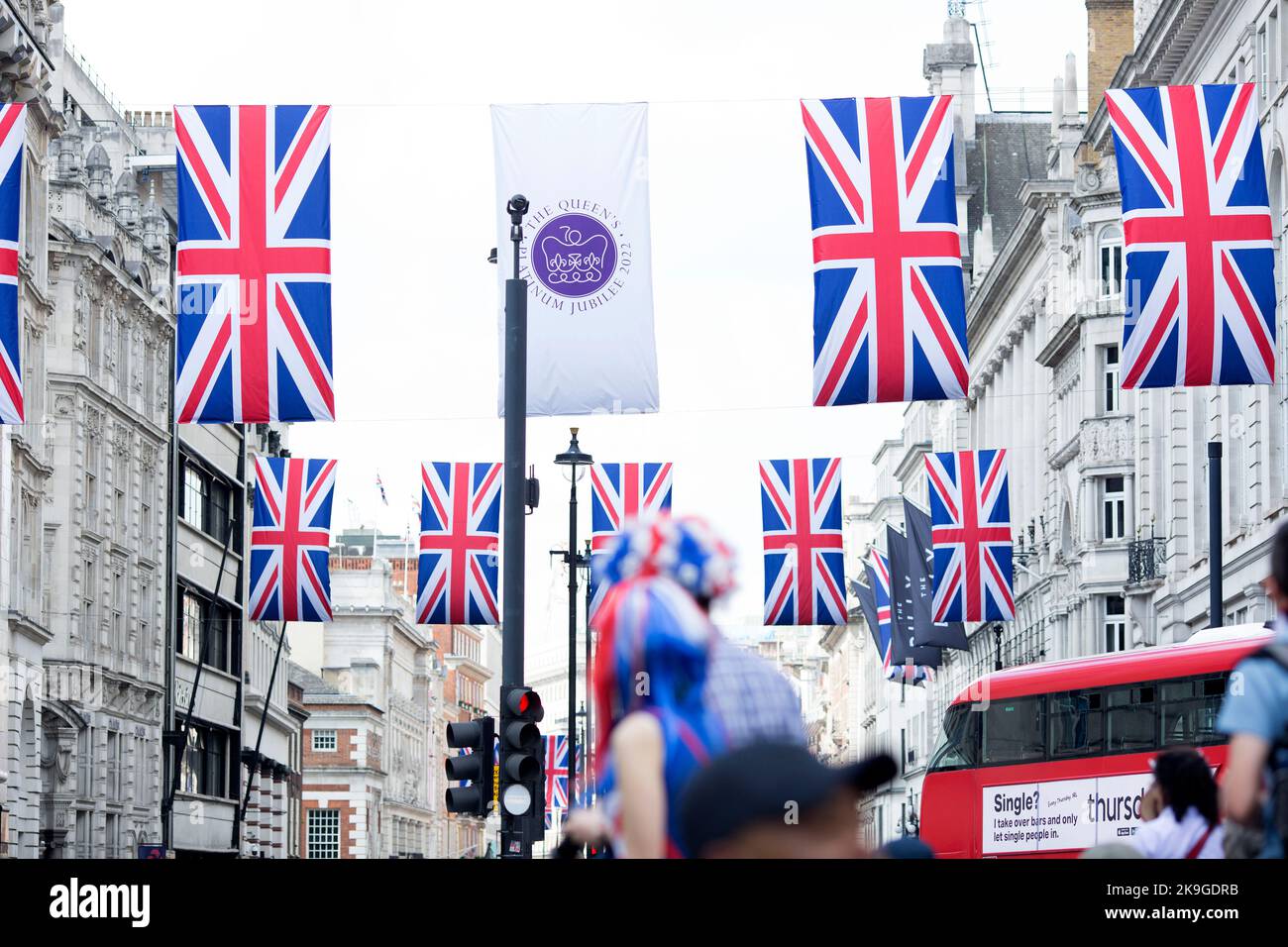 Revellers in Union Jack-themed costumes look on in Piccadilly Circus ...