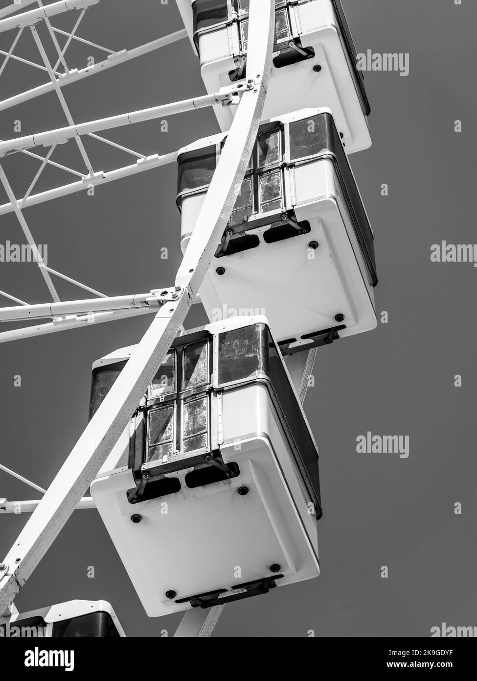 The vertical low-angle grayscale view of the Ferris wheel cabins Stock ...