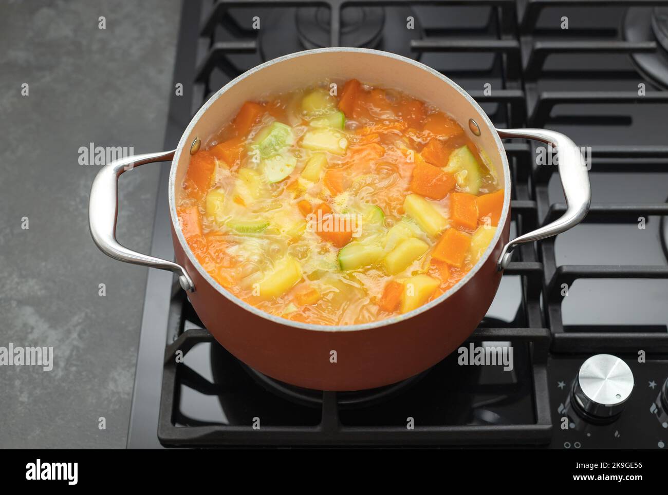 Boiling pot of pumpkin soup on gas stove top Stock Photo - Alamy