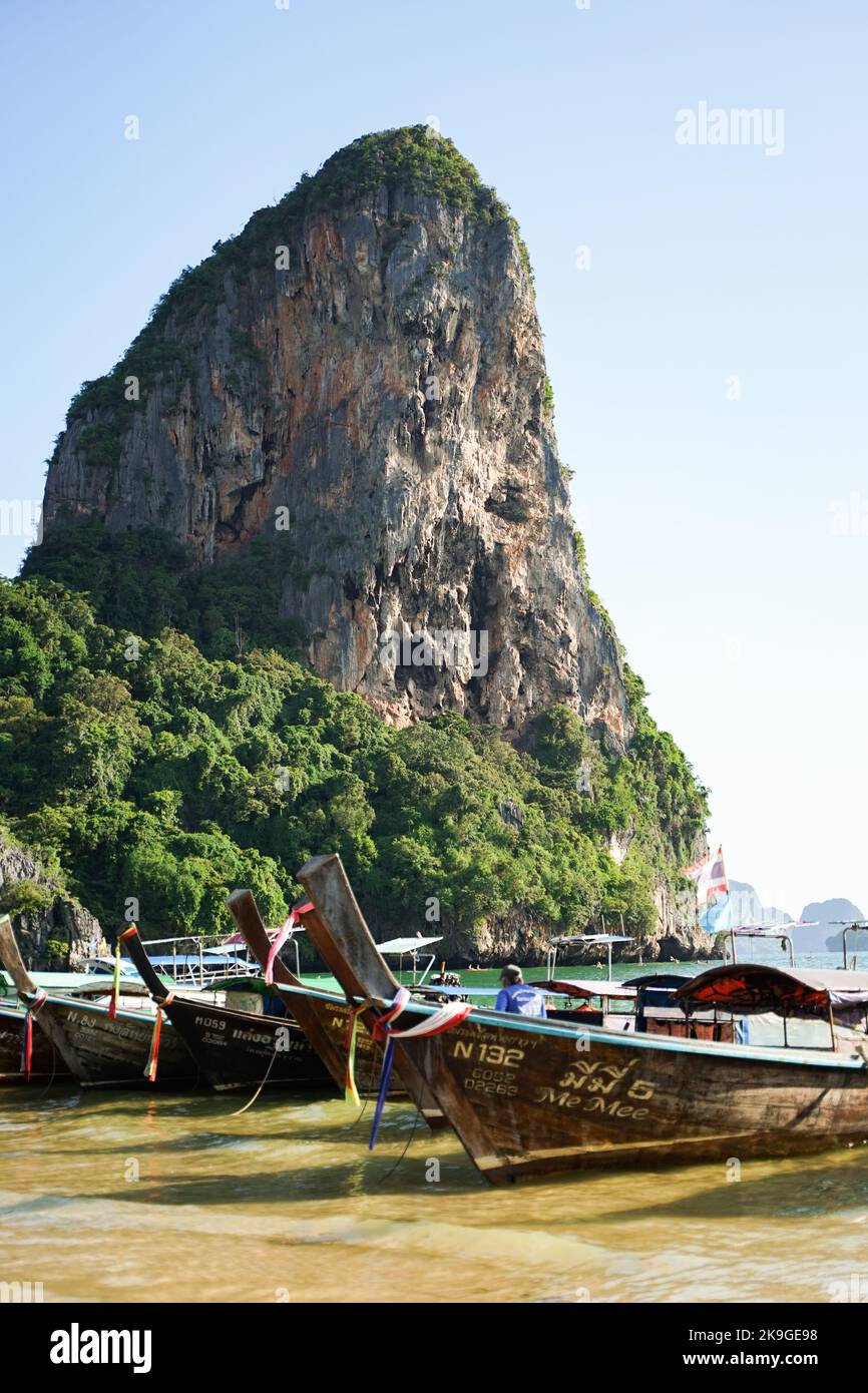 The famous rock formation on the Railay beach with long tail boats ...