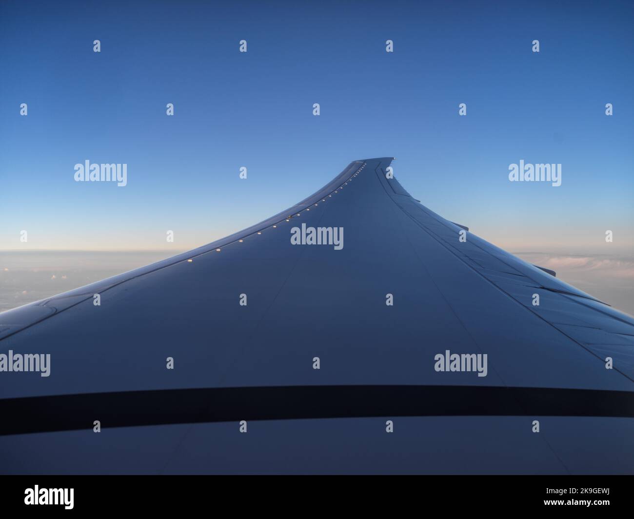 A closeup of plane wing from window of airliner Stock Photo - Alamy
