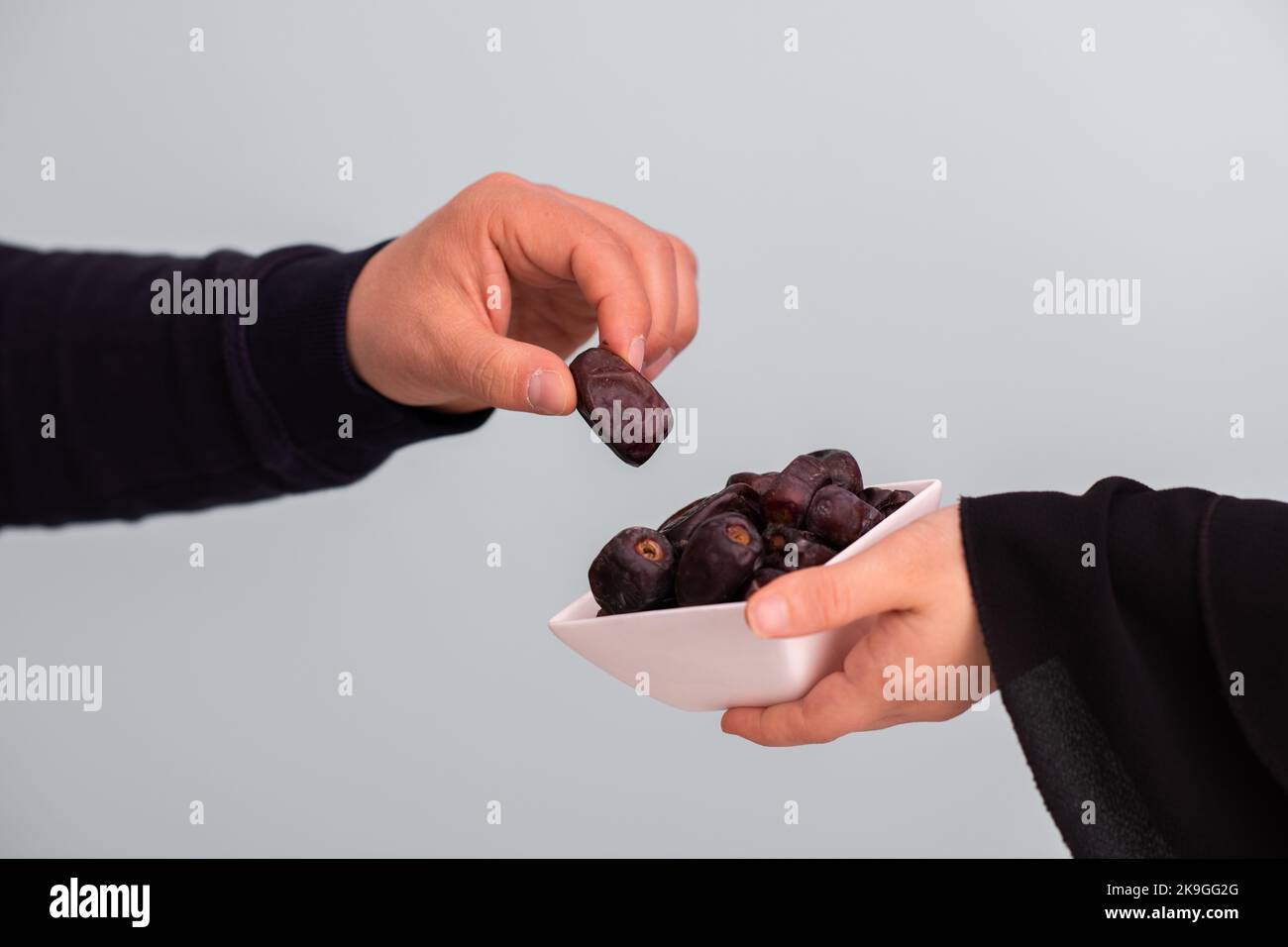 Modern Muslim Woman Holding A Plate Full Of Sweet Dates On Iftar Time