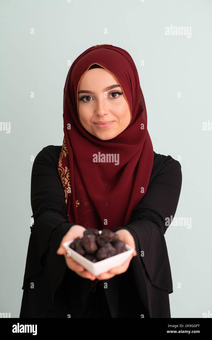 Modern Muslim Woman Holding A Plate Full Of Sweet Dates On Iftar Time