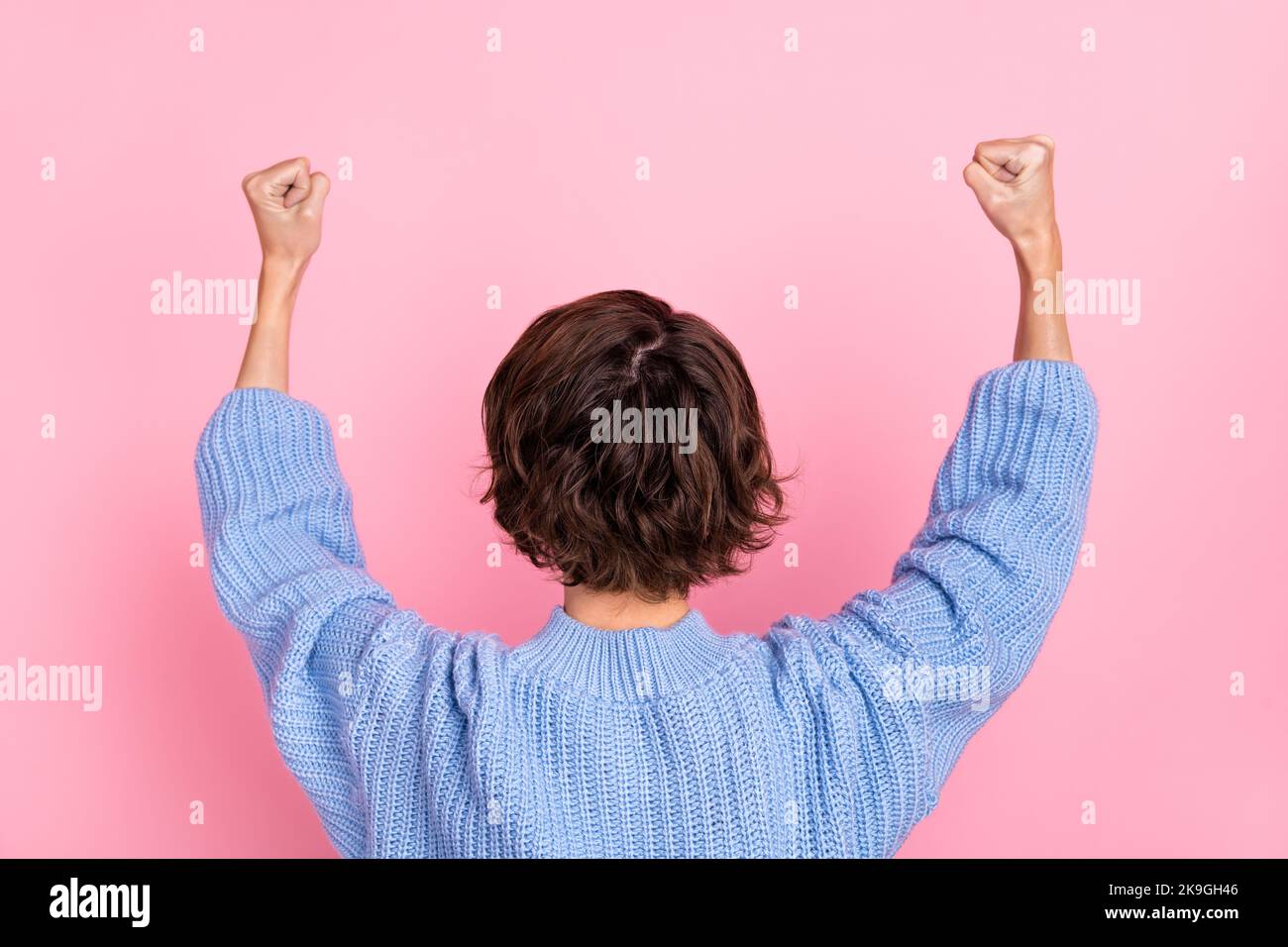 Rear spine view photo of happy lady raise hands up celebrate victory ...