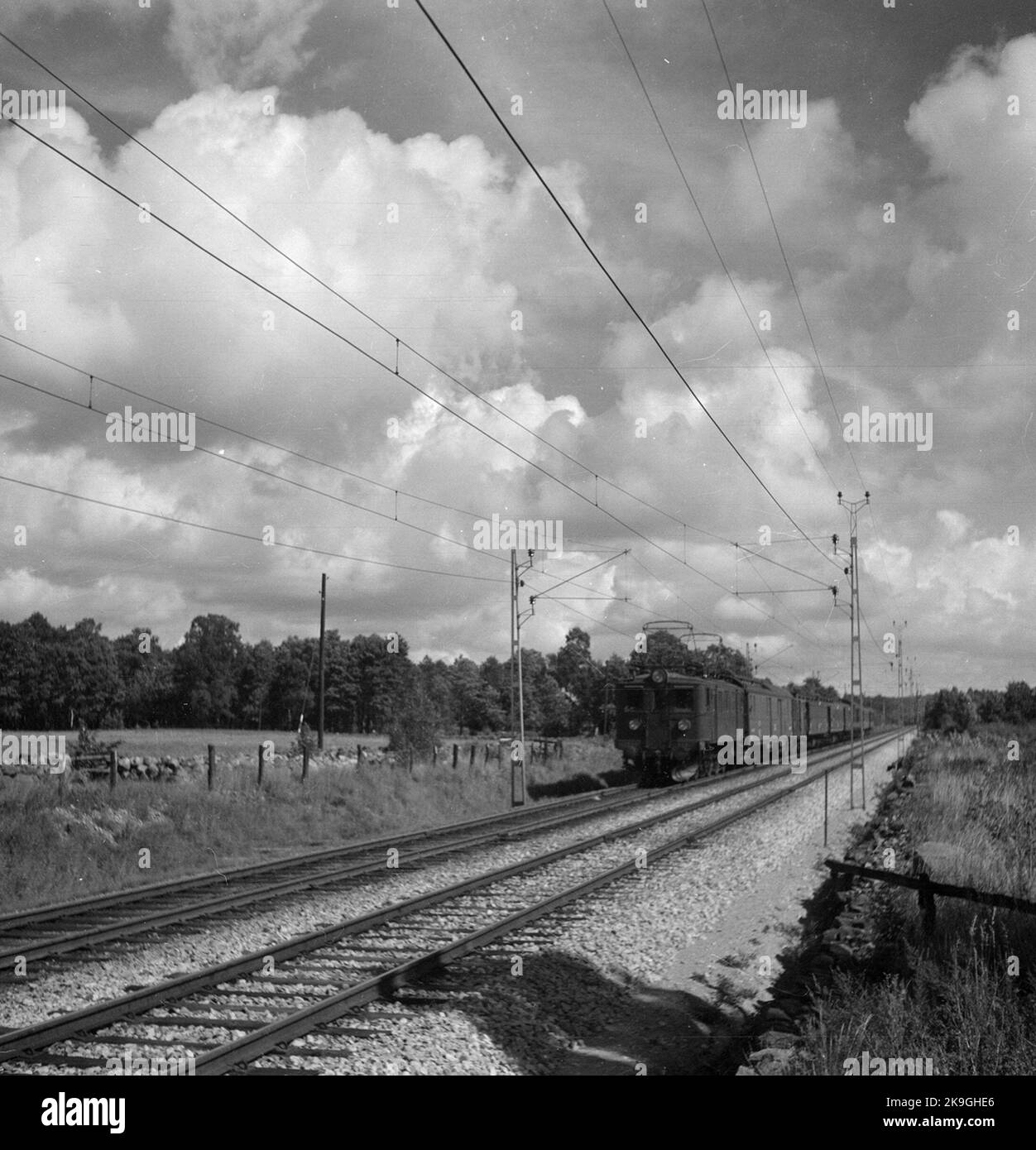 D - LOK with wagons, passenger trains on the rising track north of ...