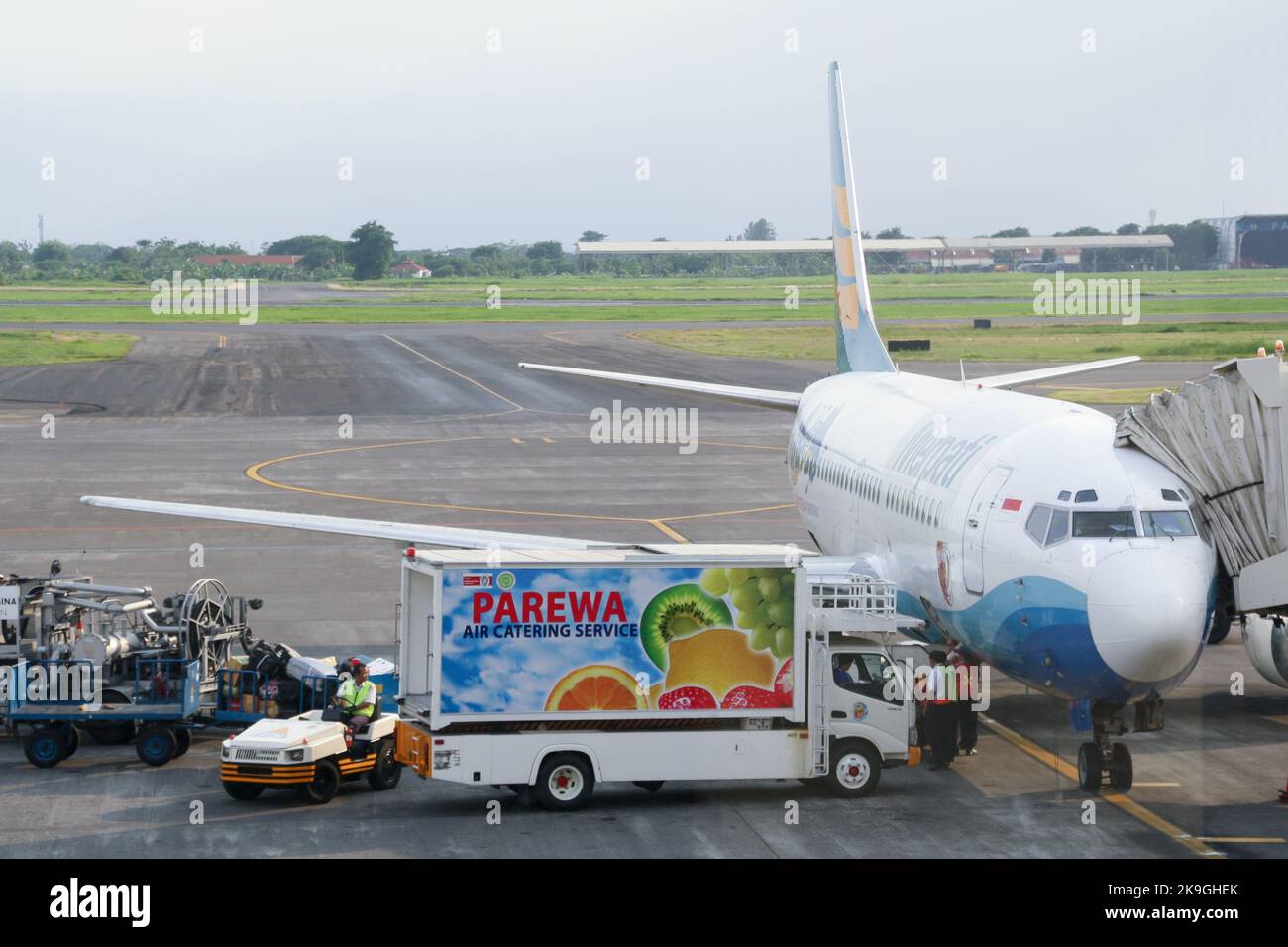 View of Merpati Airlines low cost carrier airliner on apron with ground ...