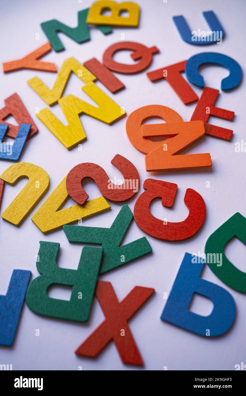 multi colored wooden letters on the white background Stock Photo - Alamy