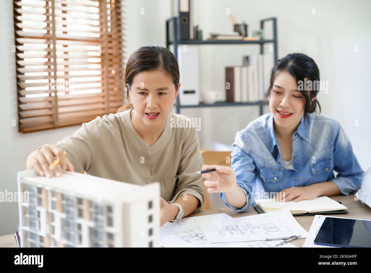 Concept of engineering consulting, Two female engineers pointing and ...