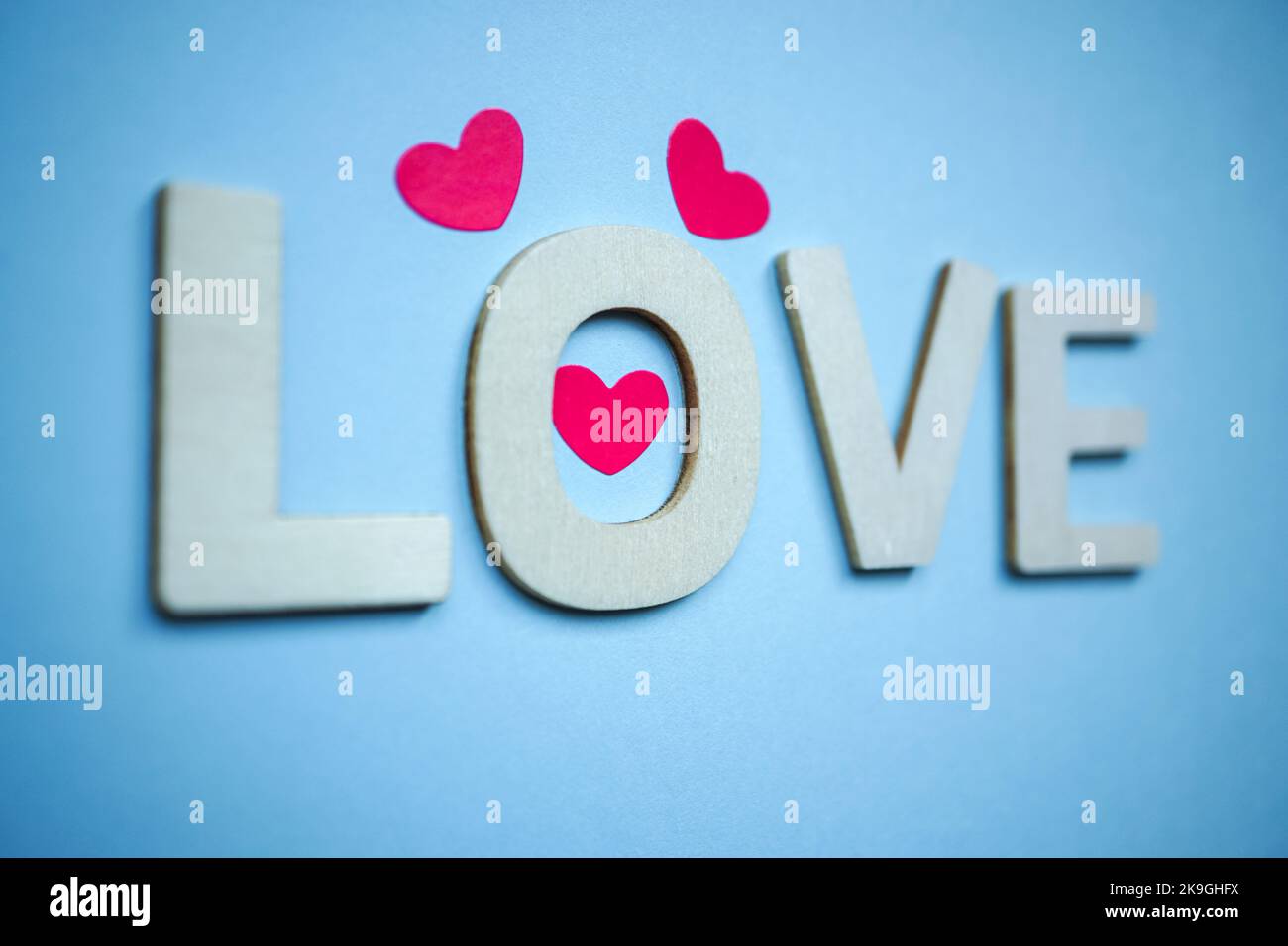 love wooden letters and heart shapes on the blue background for ...