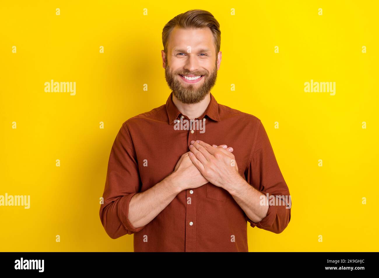 Photo of positive friendly young man beaming smile arms touch chest ...