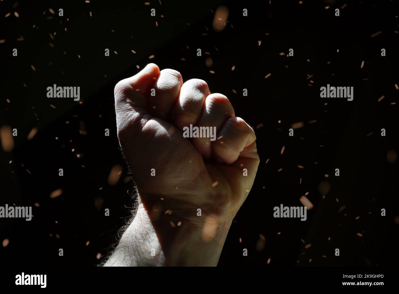 man hand up gesturing in the shadows, dark background Stock Photo - Alamy