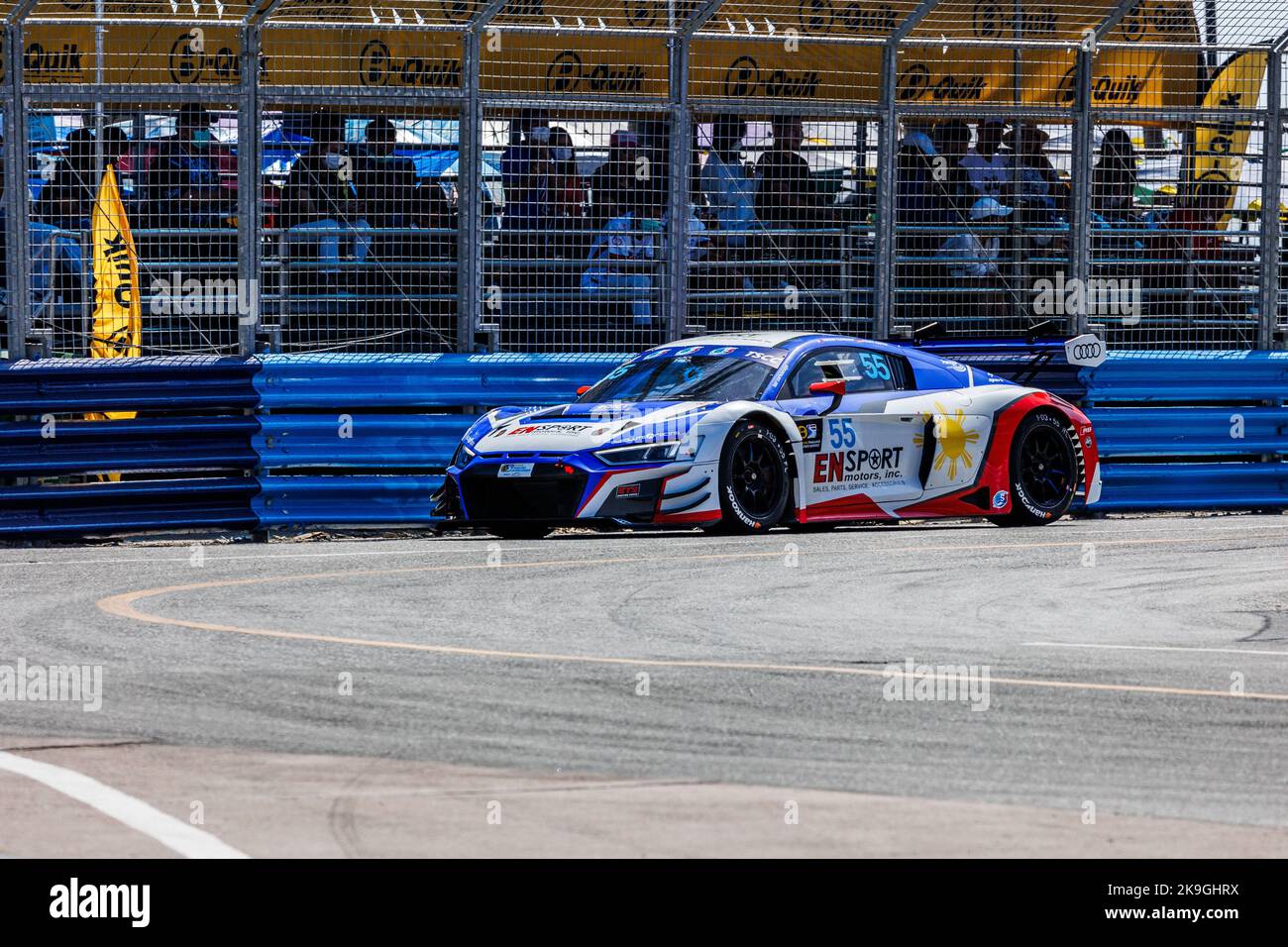 A red and blue supercar racing at a street circuit during Grand Prix ...