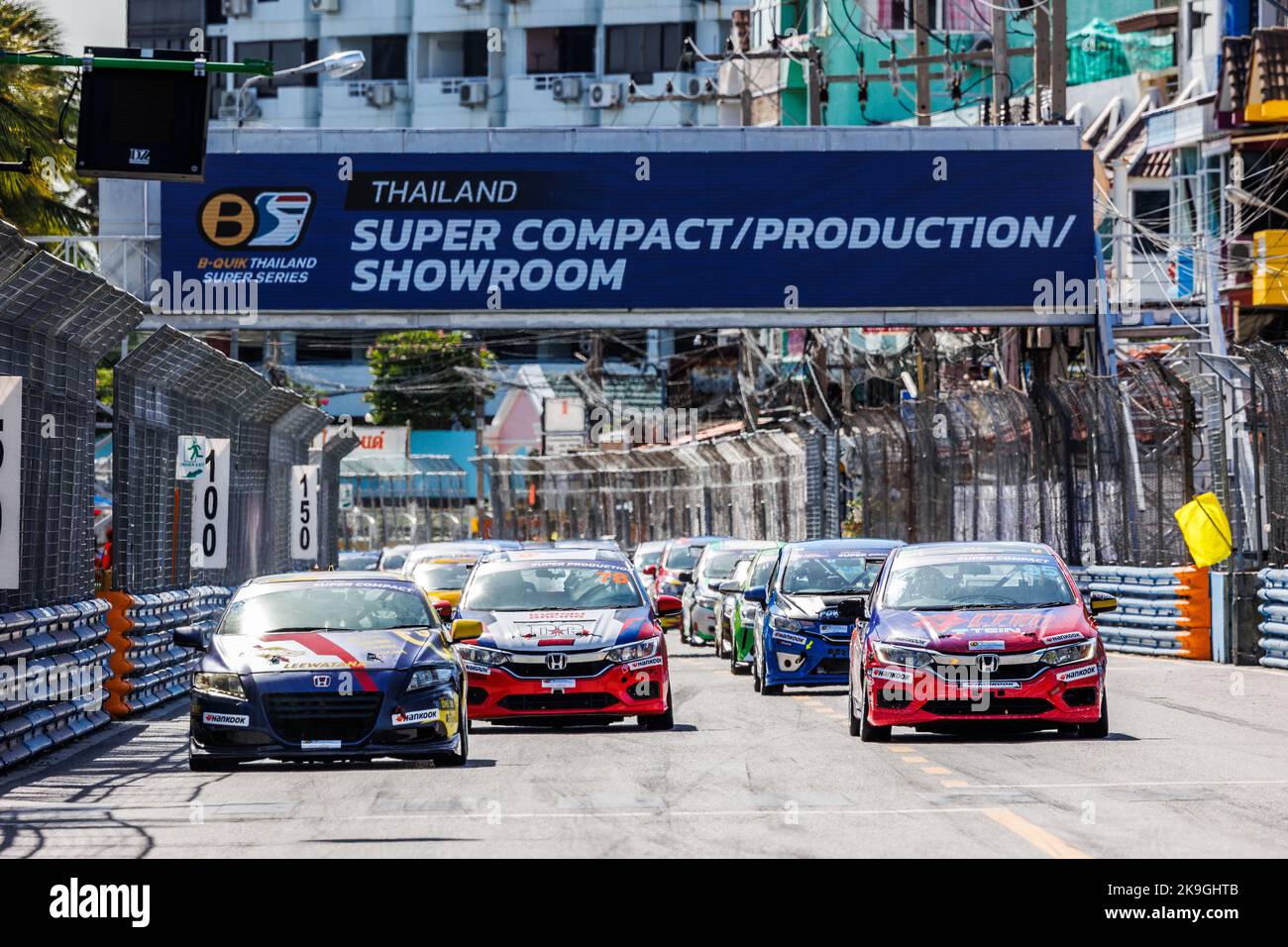 A supercar racing with red and blue cars moving forward at a street ...