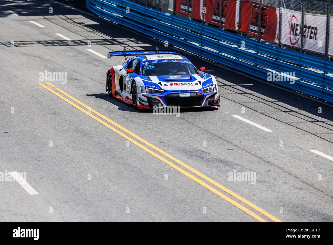 A red and blue supercar racing at a street circuit during Grand Prix ...