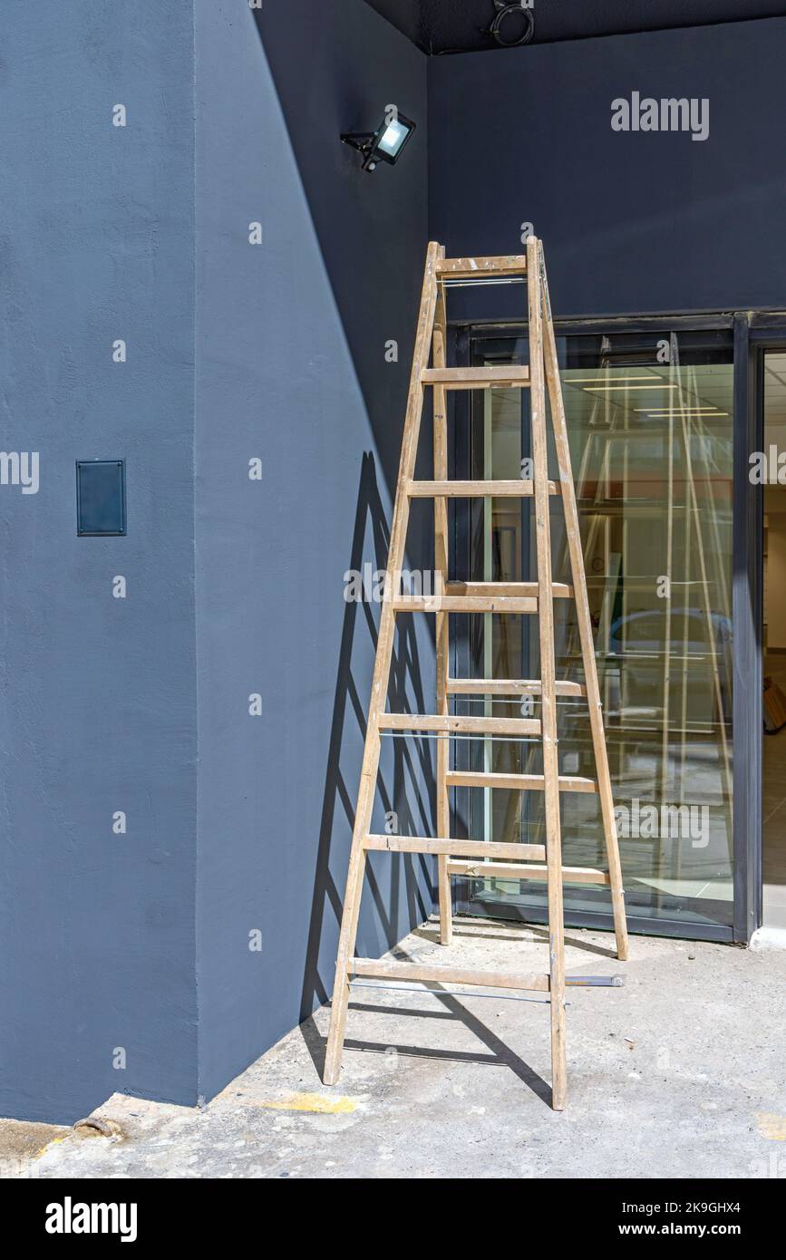Tall Wooden Ladder at Building Exterior Works Mounting Led Reflector ...