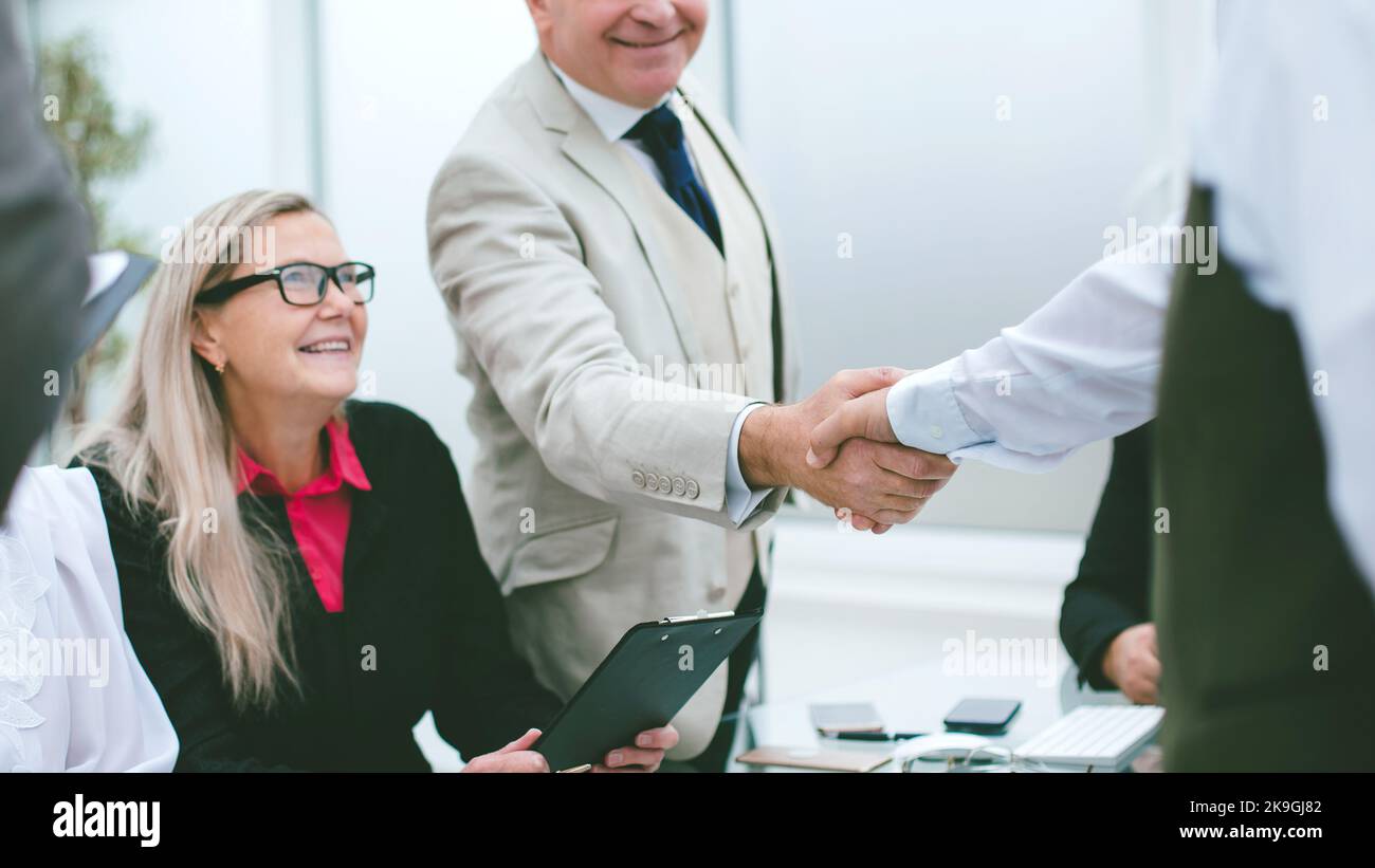 close up. business people shaking hands before negotiations. the ...