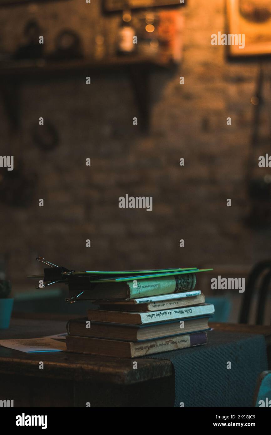 The books on a table inside a cafe bar Stock Photo - Alamy