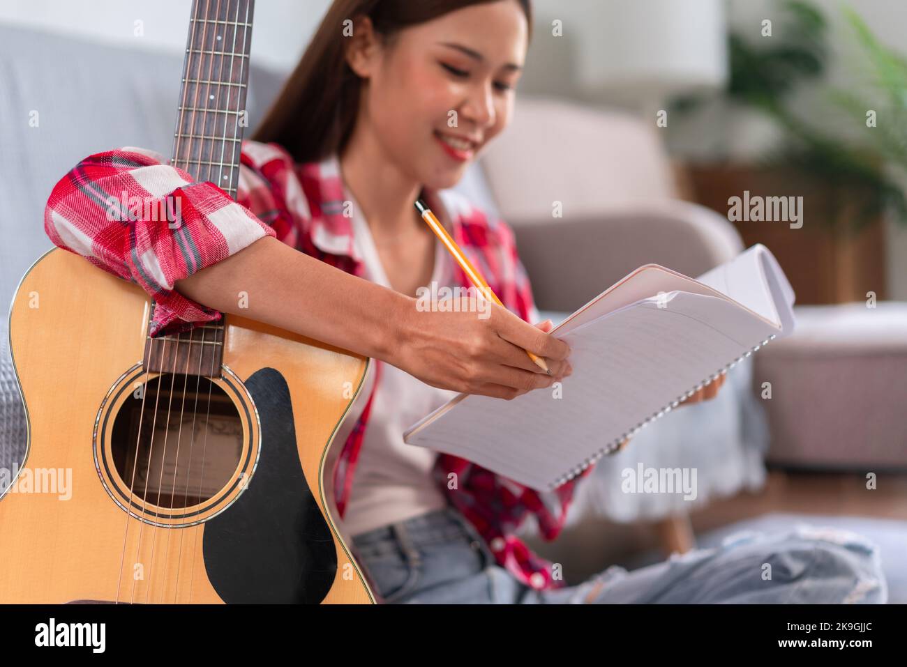 Concept of relaxation with music, Young woman is composing new song and ...