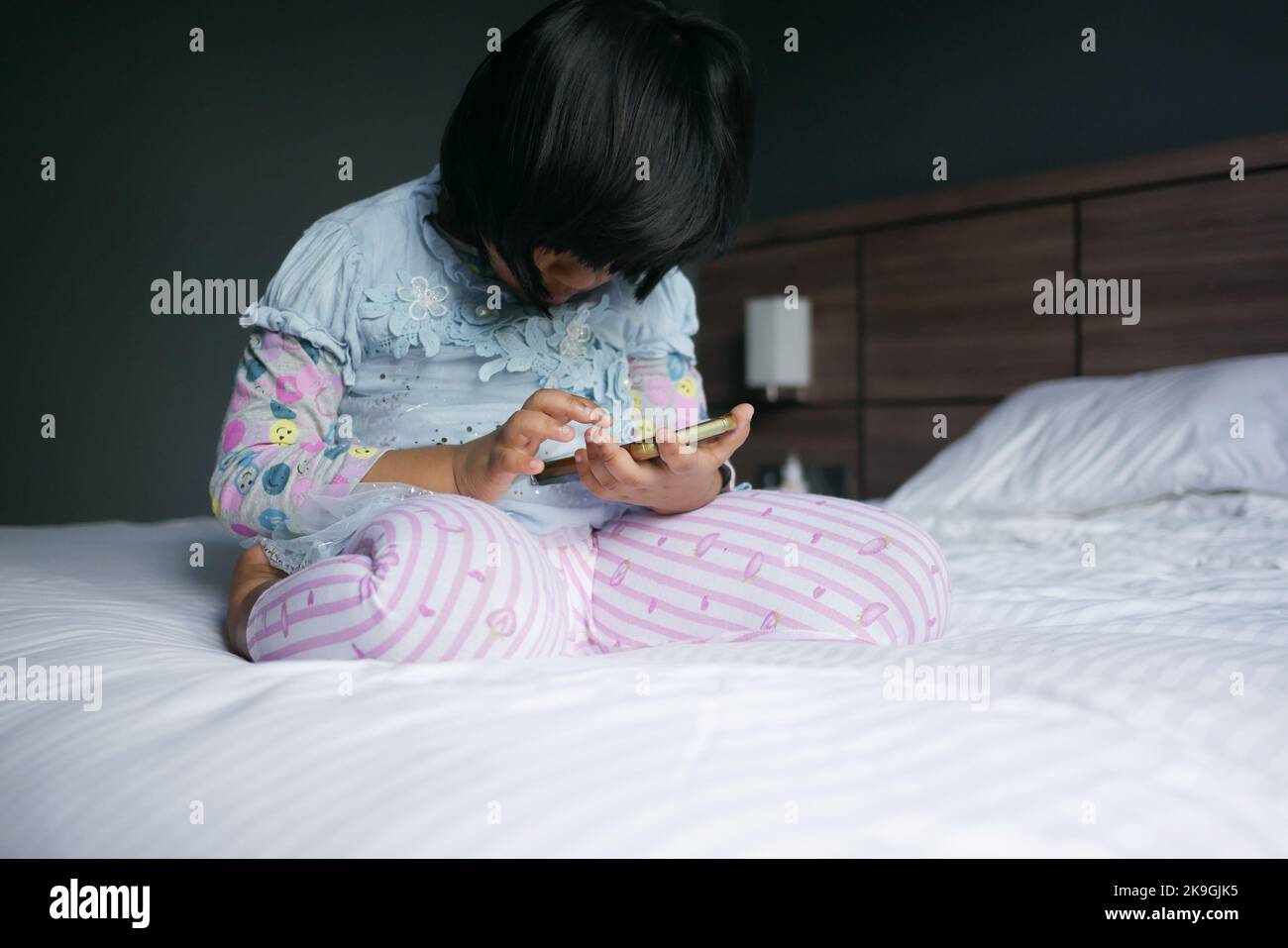 Child girl watching cartoon on smart phone Stock Photo - Alamy