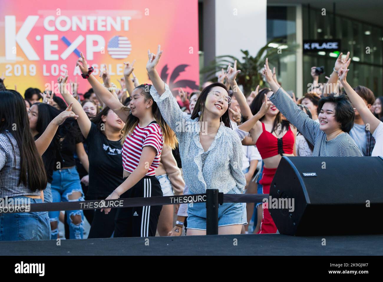 A crowd of fans of KPop participating in a group dance activity called ...