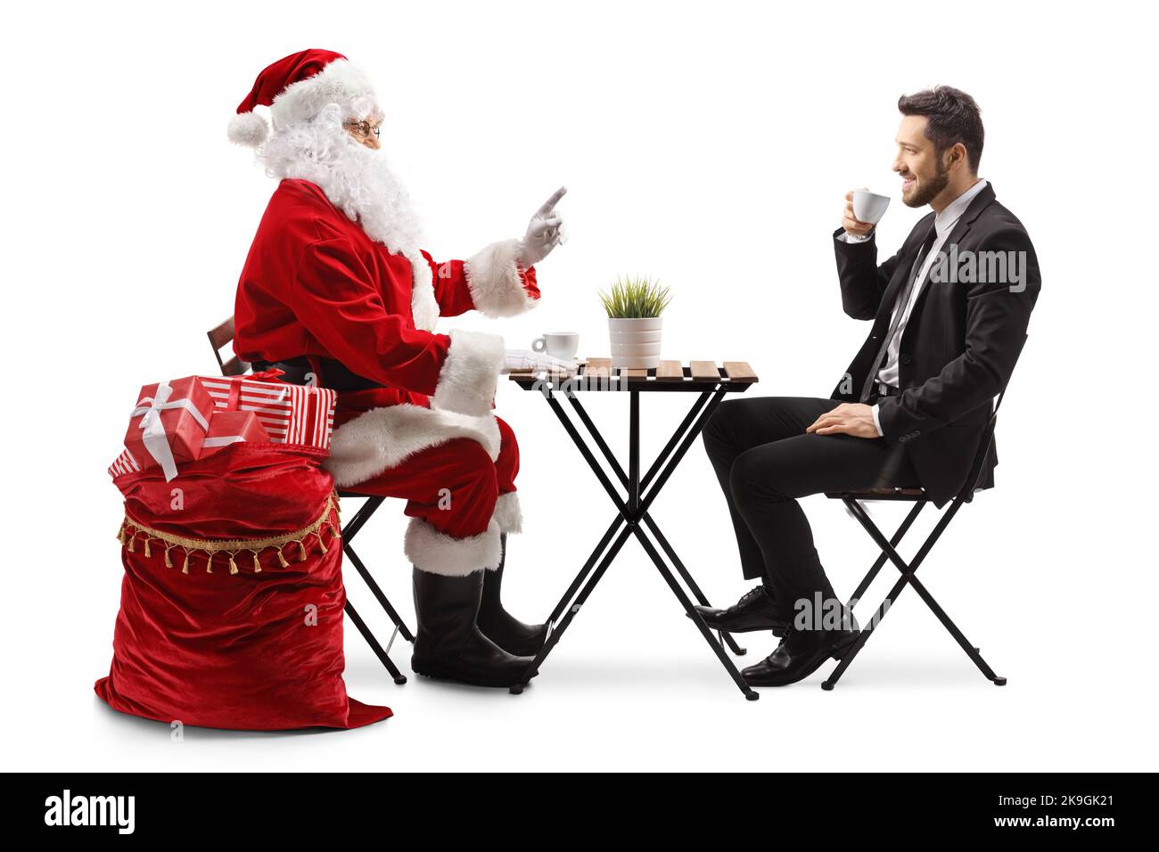 Santa Claus talking to a businessman in a cafe isolated on white ...