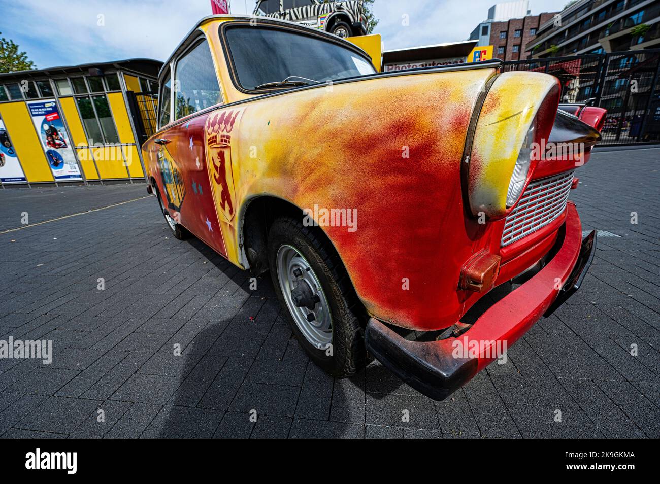 A wide-angle shot of a classic Trabant car parked in front of the ...