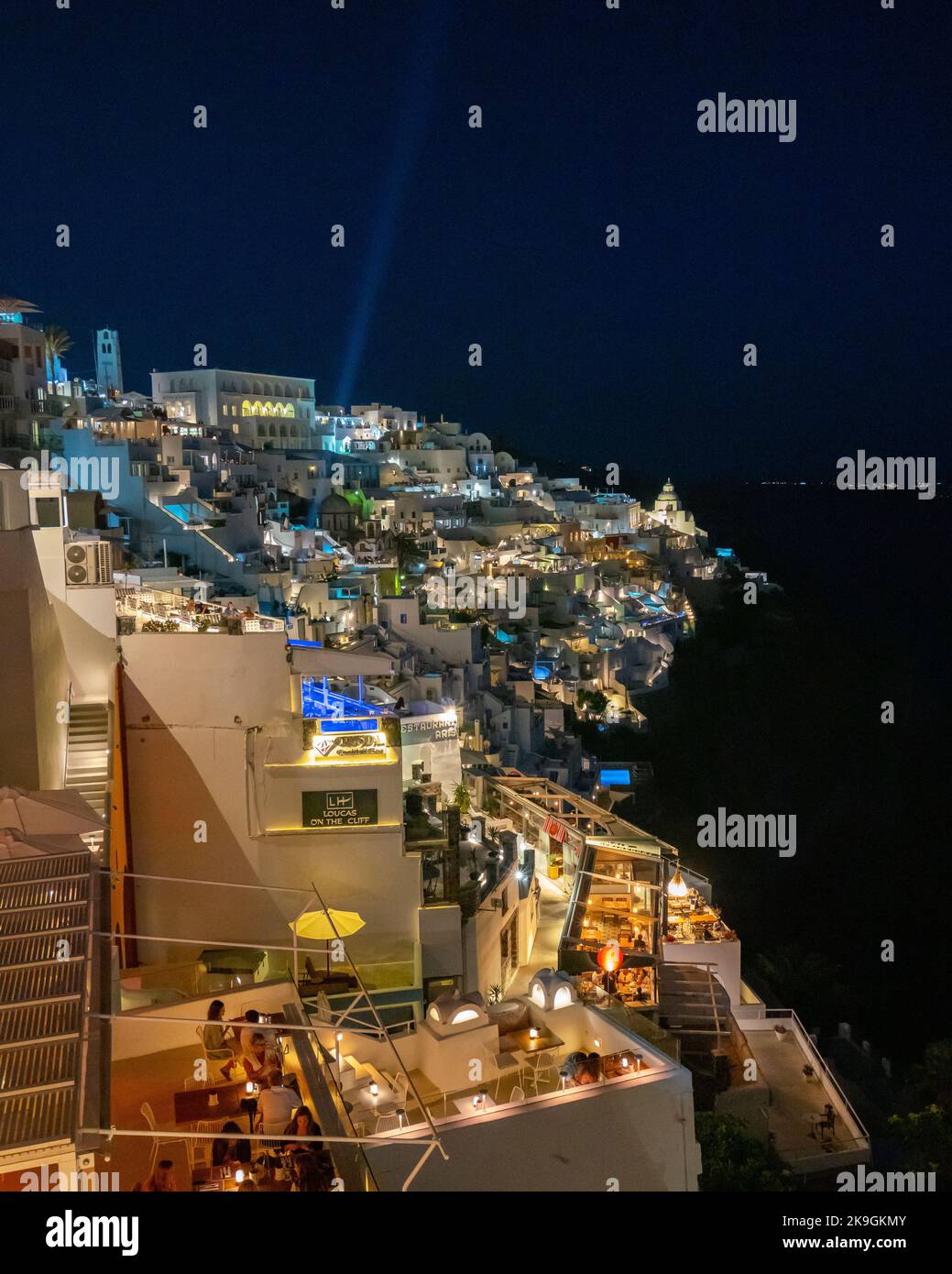 The downtown cityscape of Santorini Greece at night with many lights ...