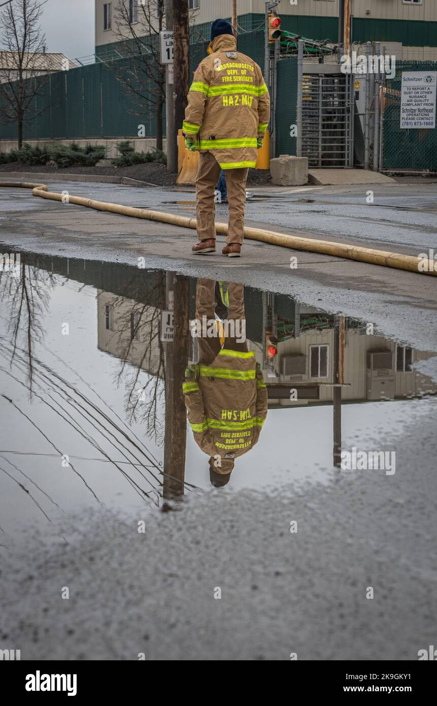 A firefighter walking at an industrial site Stock Photo - Alamy