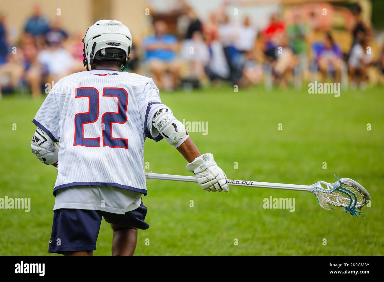A lacrosse player in the field in action Stock Photo - Alamy