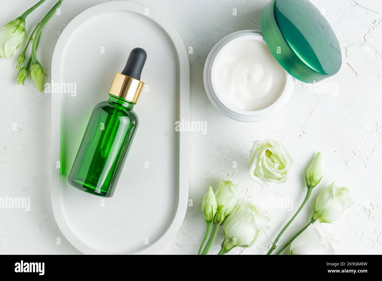 Moisturizing cream in a jar and face beauty oil in dropper bottle ...