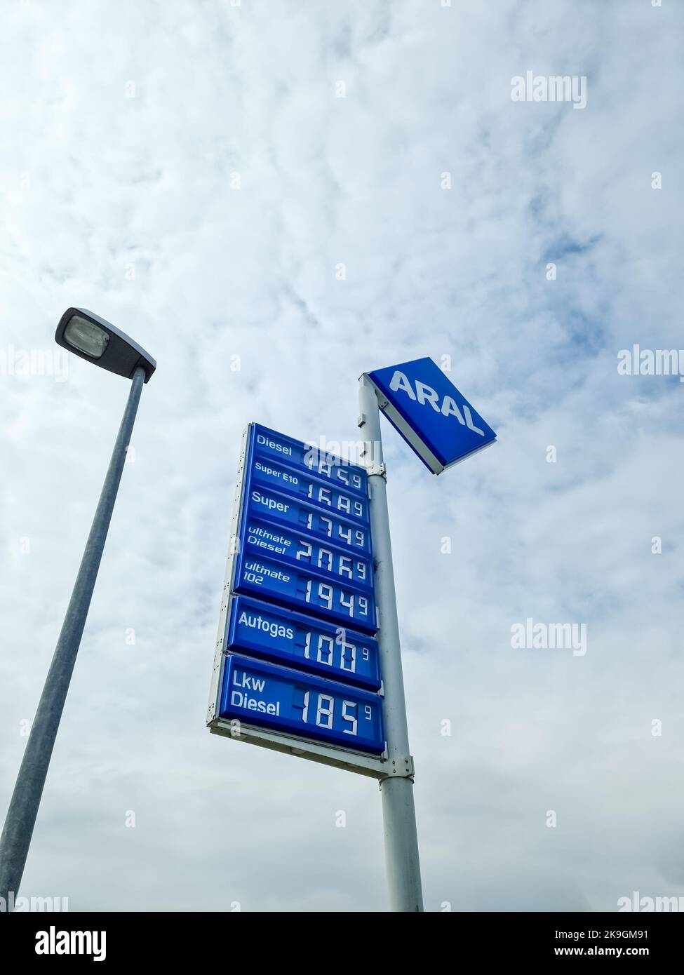 a low angle shot of the price board with petrol and diesel prices of an ...