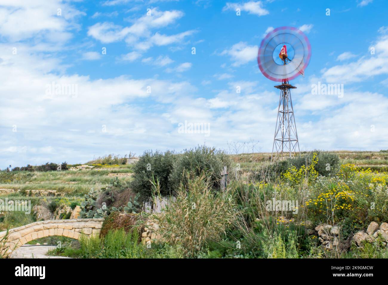 A functioning wind pump, with rotating multi bladed rotor in motion ...