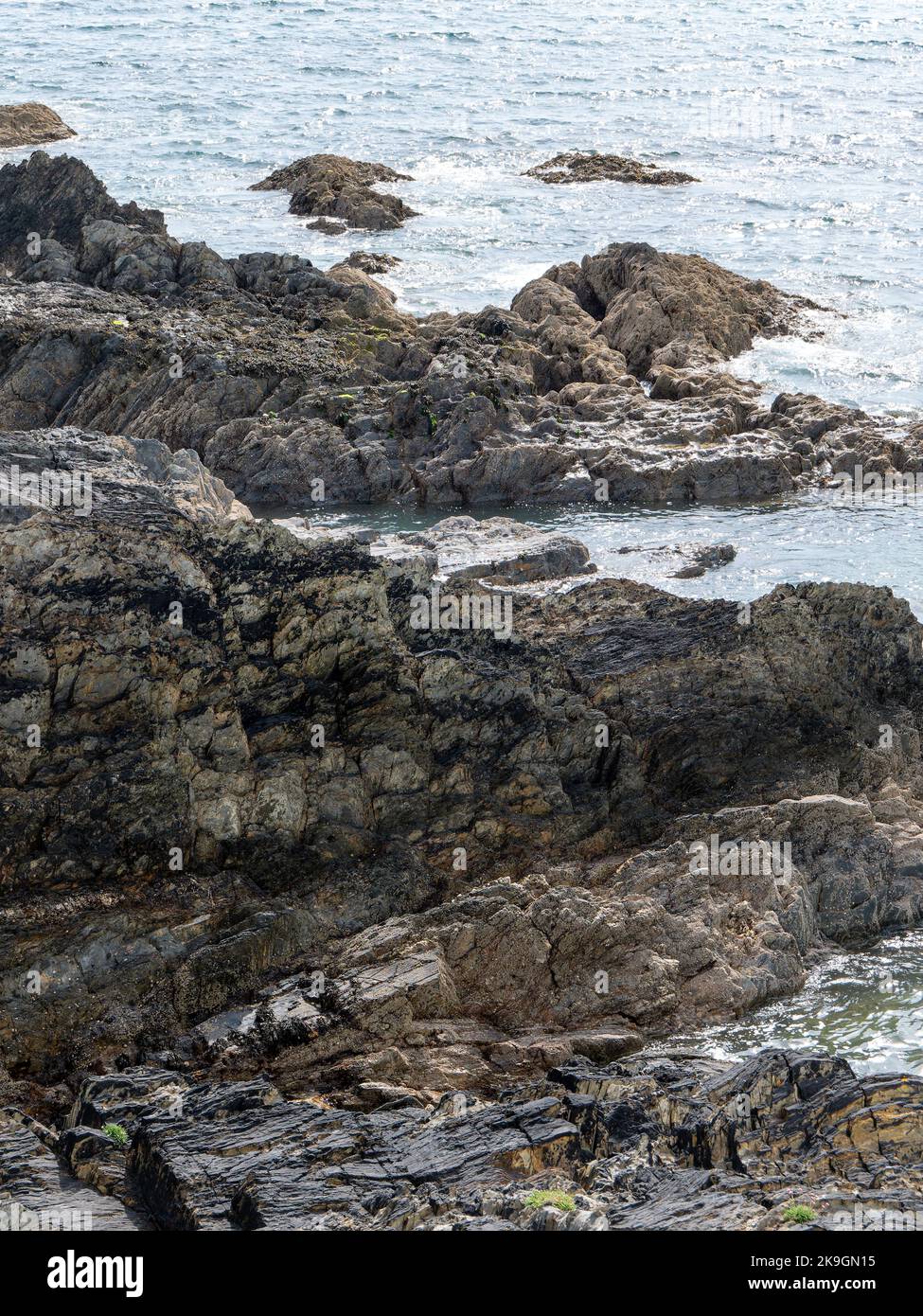 Exposed rocks on the shore. Seaside in sunny weather, rock formation ...