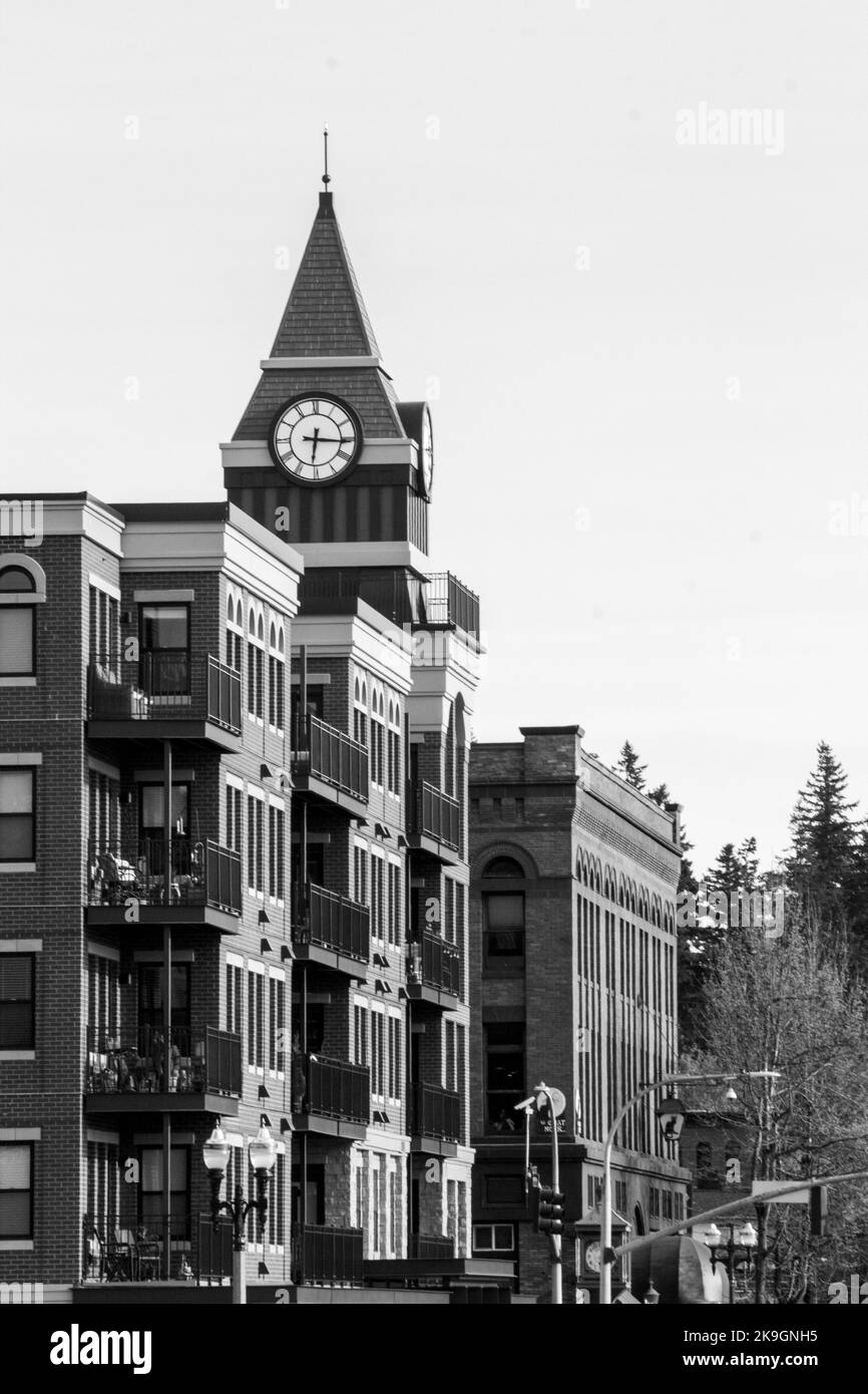 A grayscale of a building with a clock tower Stock Photo - Alamy
