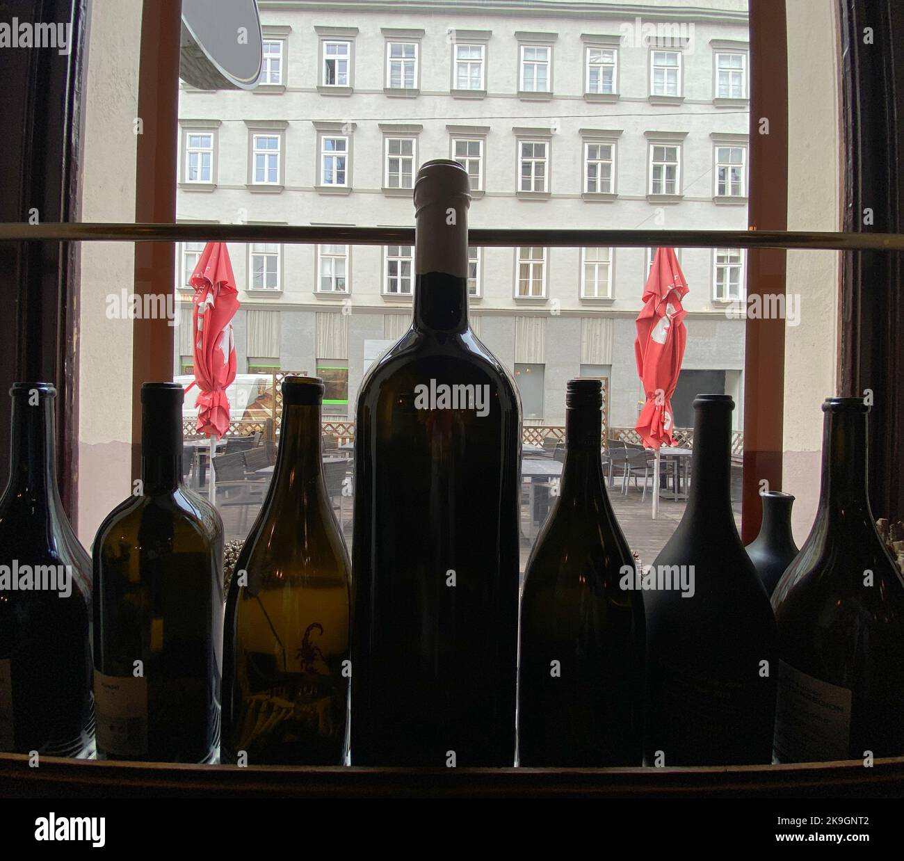 Street on the background of vintage bottles standing on the bar ...