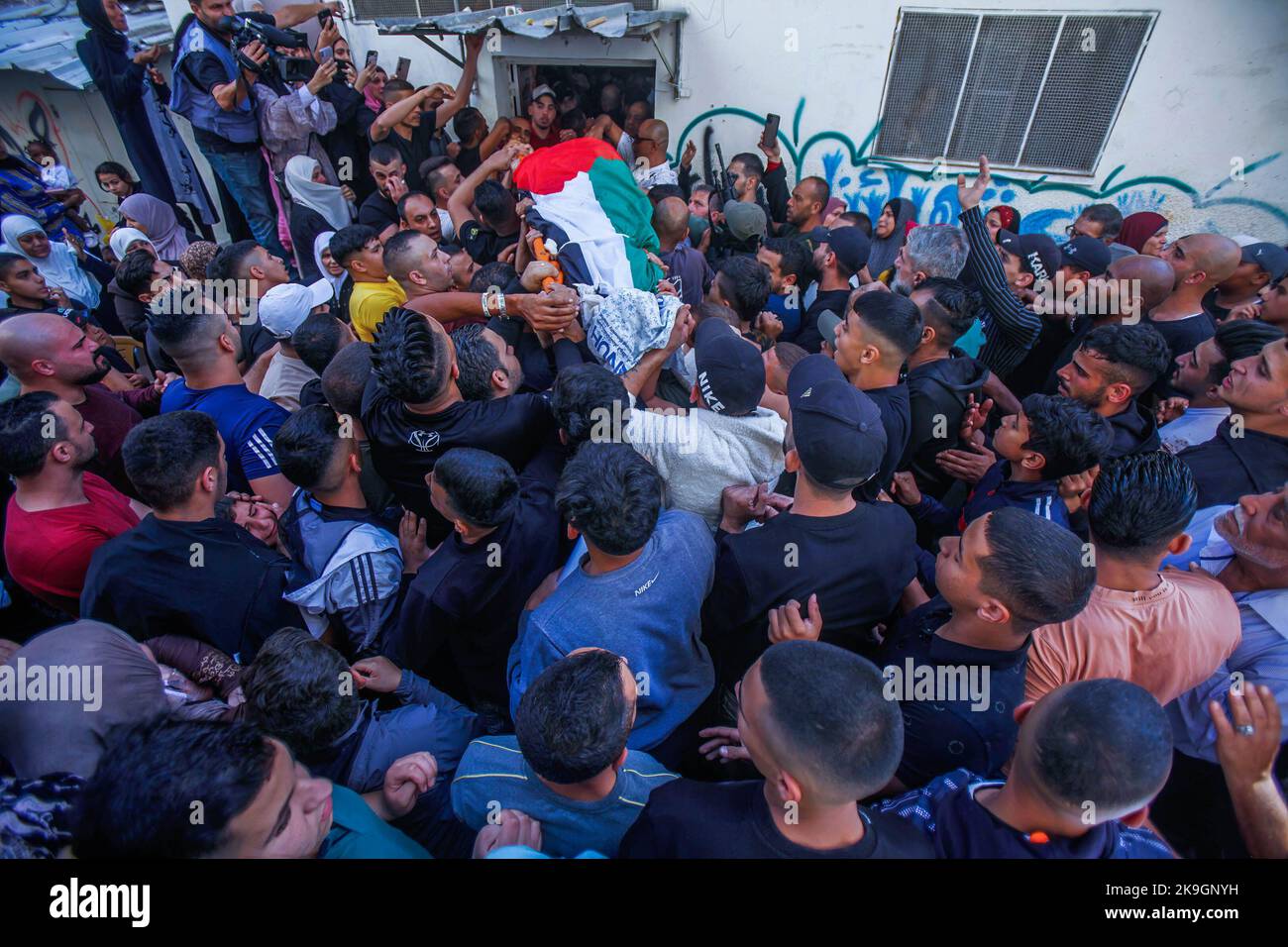 (Editors note image depicts death) Mourners carry the body of ...