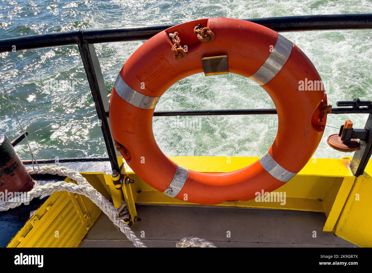 Orange rescue ring on a ferry boat Stock Photo - Alamy