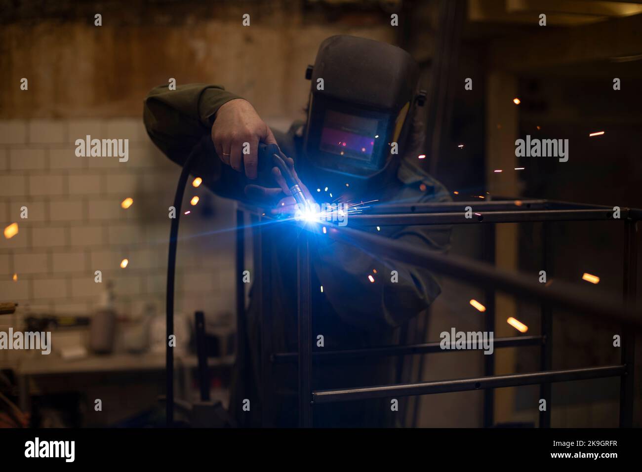 Welding work on metal. Blue fire from high temperature. Creation of ...